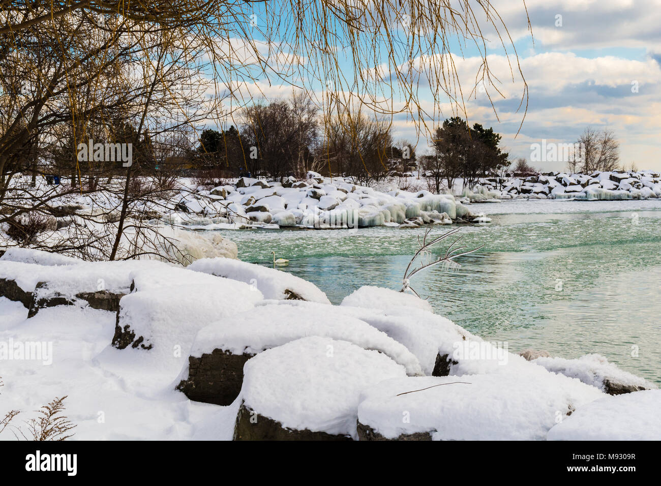 Winter Landscape Scene showing white snow along icy water lake coastal ...