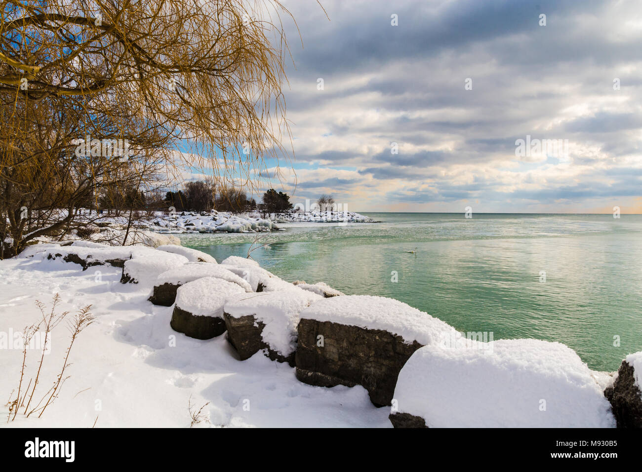 Winter Landscape Scene showing white snow along icy water lake coastal ...