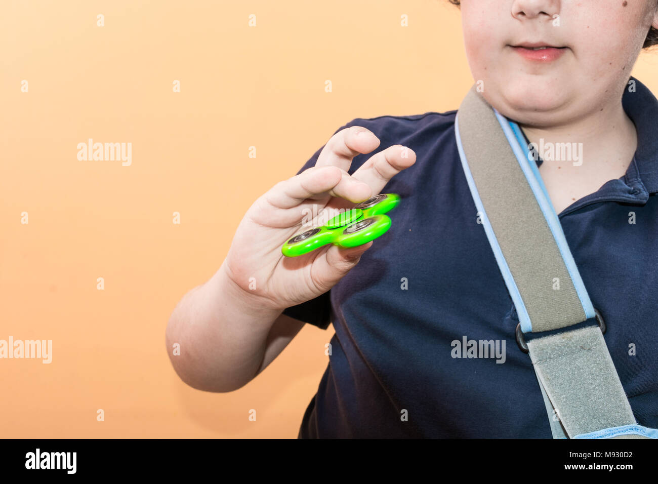 Boy playing with fidget spinner gadget. The fidget spinner is a toy, a ...