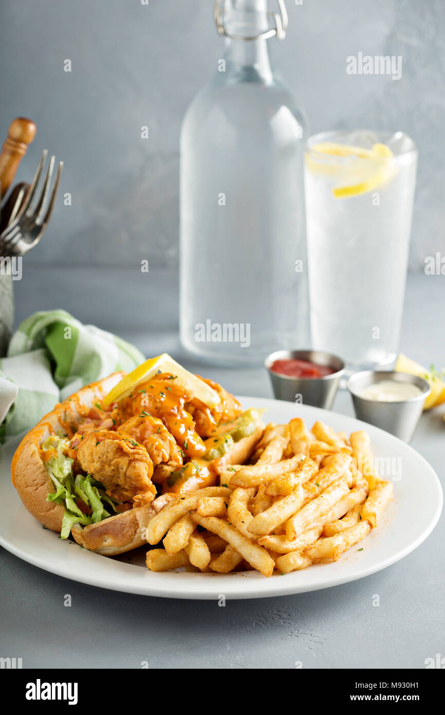 Po boy sandwich with fried shrimp and fries Stock Photo - Alamy