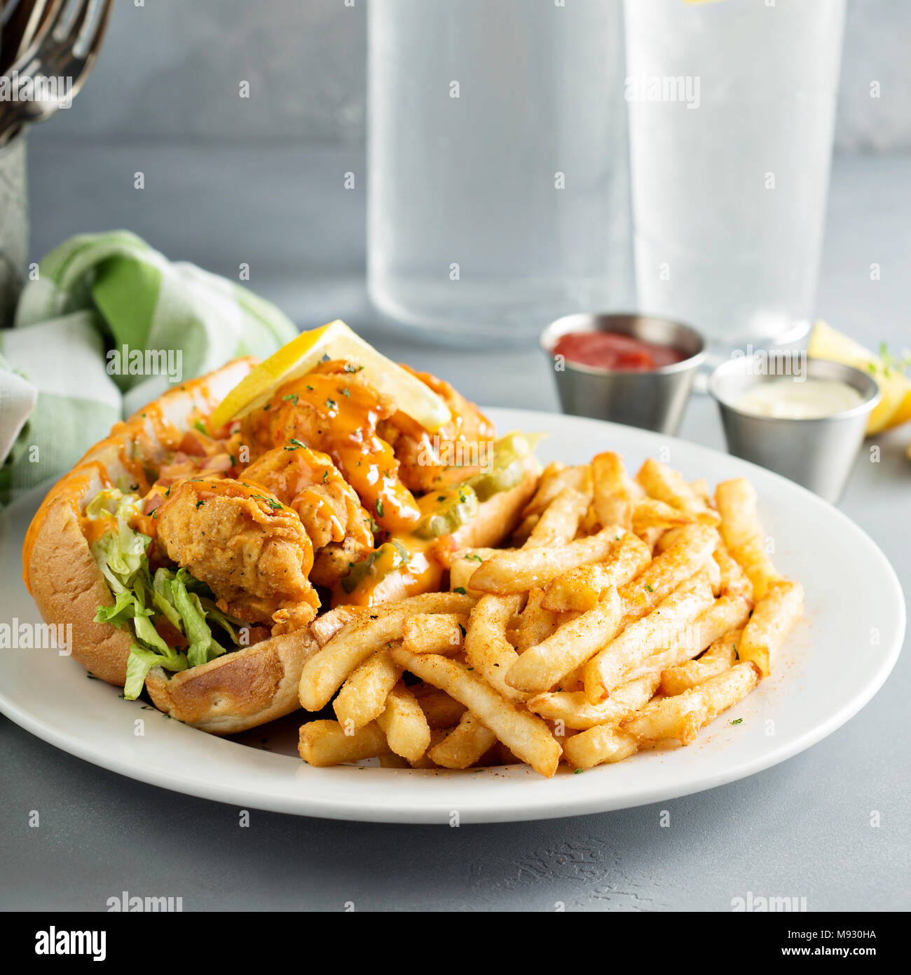 Po boy sandwich with fried shrimp and fries Stock Photo - Alamy