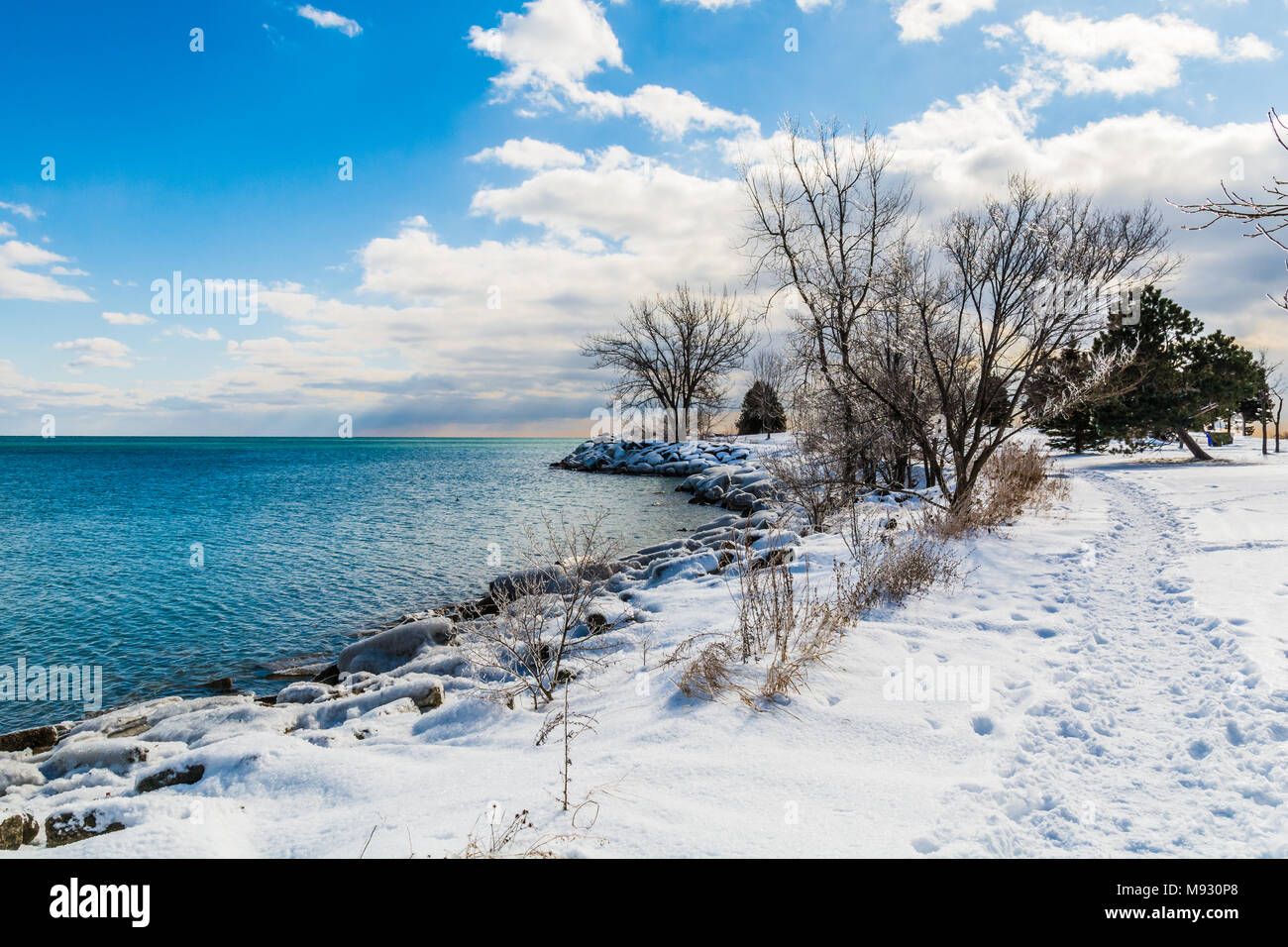 Winter Landscape Scene showing white snow along icy water lake coastal ...
