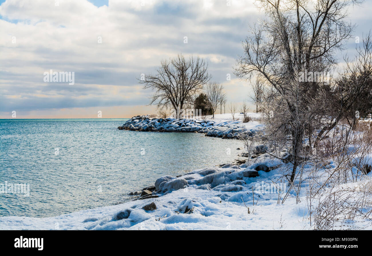 Winter Landscape Scene showing white snow along icy water lake coastal ...