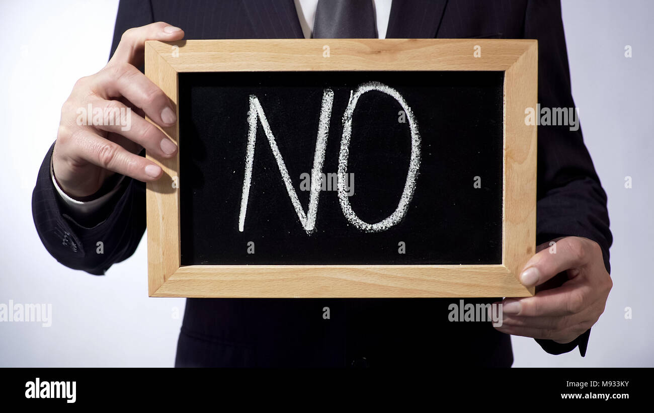 No written on blackboard, businessman holding sign, calling to stop ...