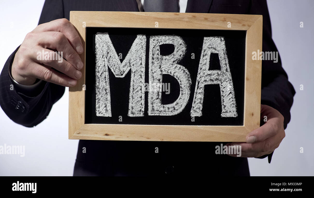 MBA written on blackboard, business person holding sign, business ...