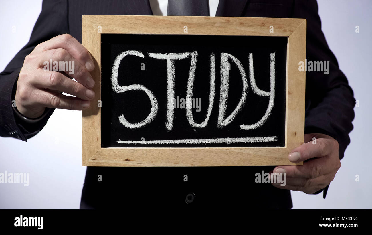 Study written on blackboard, businessman holding sign, career and ...