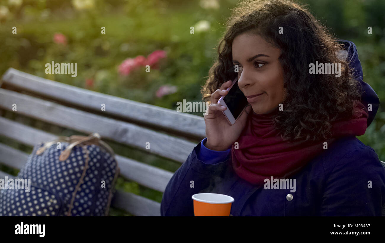 Smiling female student talking over phone, making appointment with ...