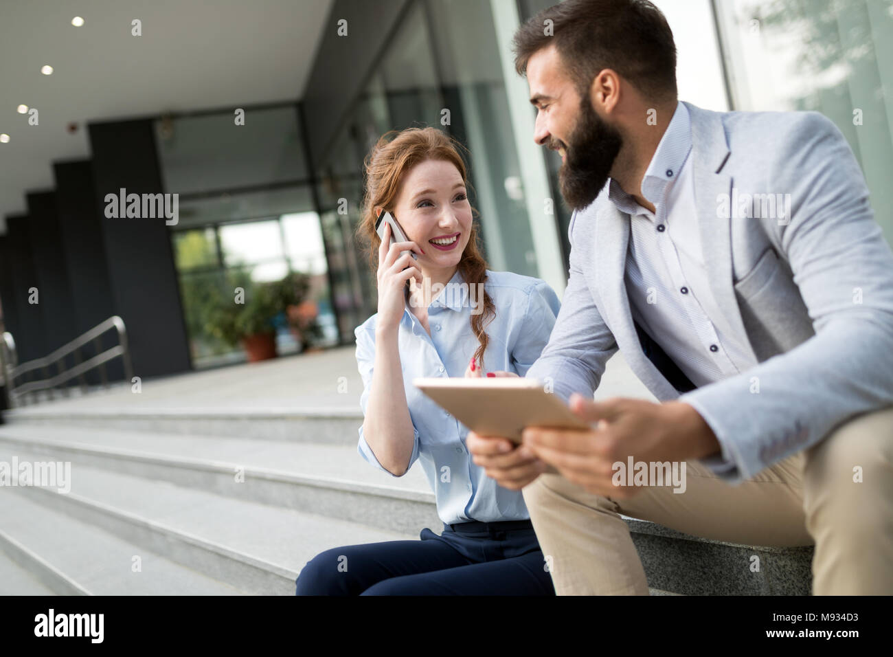 Business partners workmate couple talking in an urban city Stock Photo ...