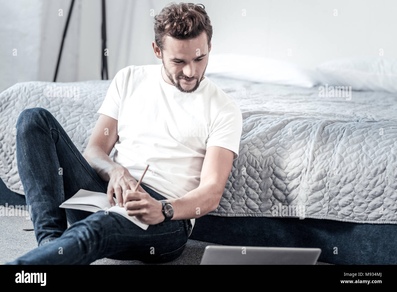 Nice handsome man holding a pencil Stock Photo - Alamy