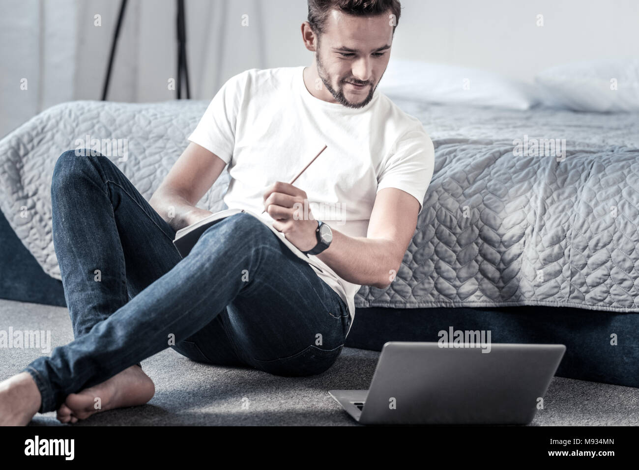 Happy nice man taking notes Stock Photo - Alamy