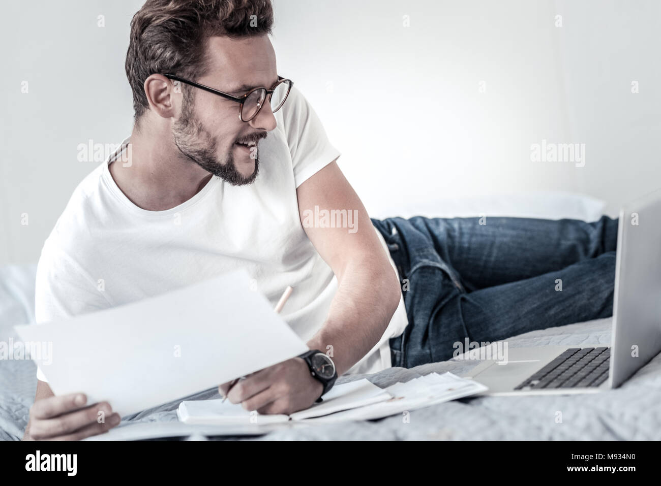 Cheerful intelligent man being involved in work Stock Photo - Alamy