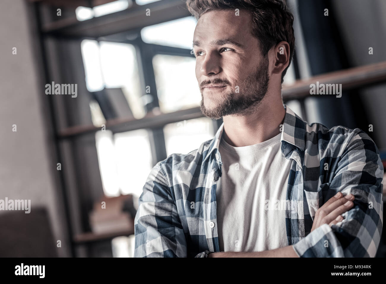 Joyful handsome man standing cross handed Stock Photo - Alamy