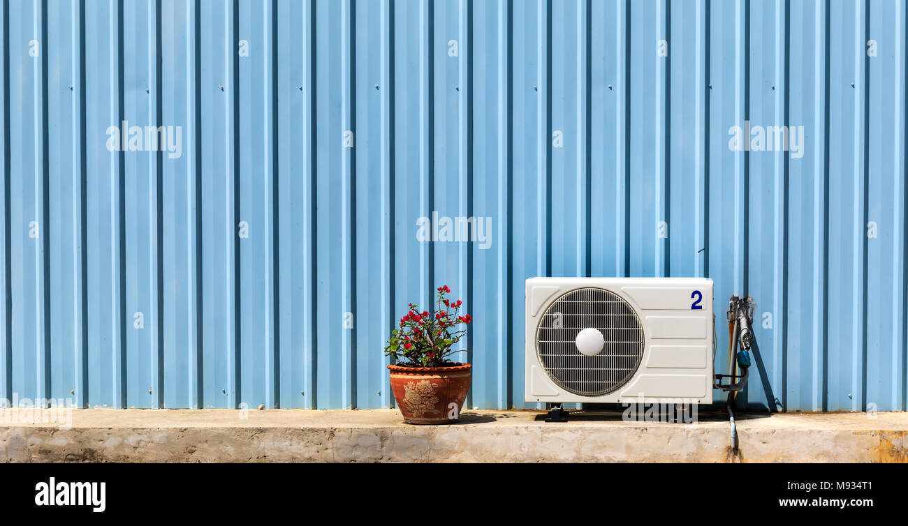Old compressor air-conditioner and Flower Pot on zinc wall Stock Photo ...
