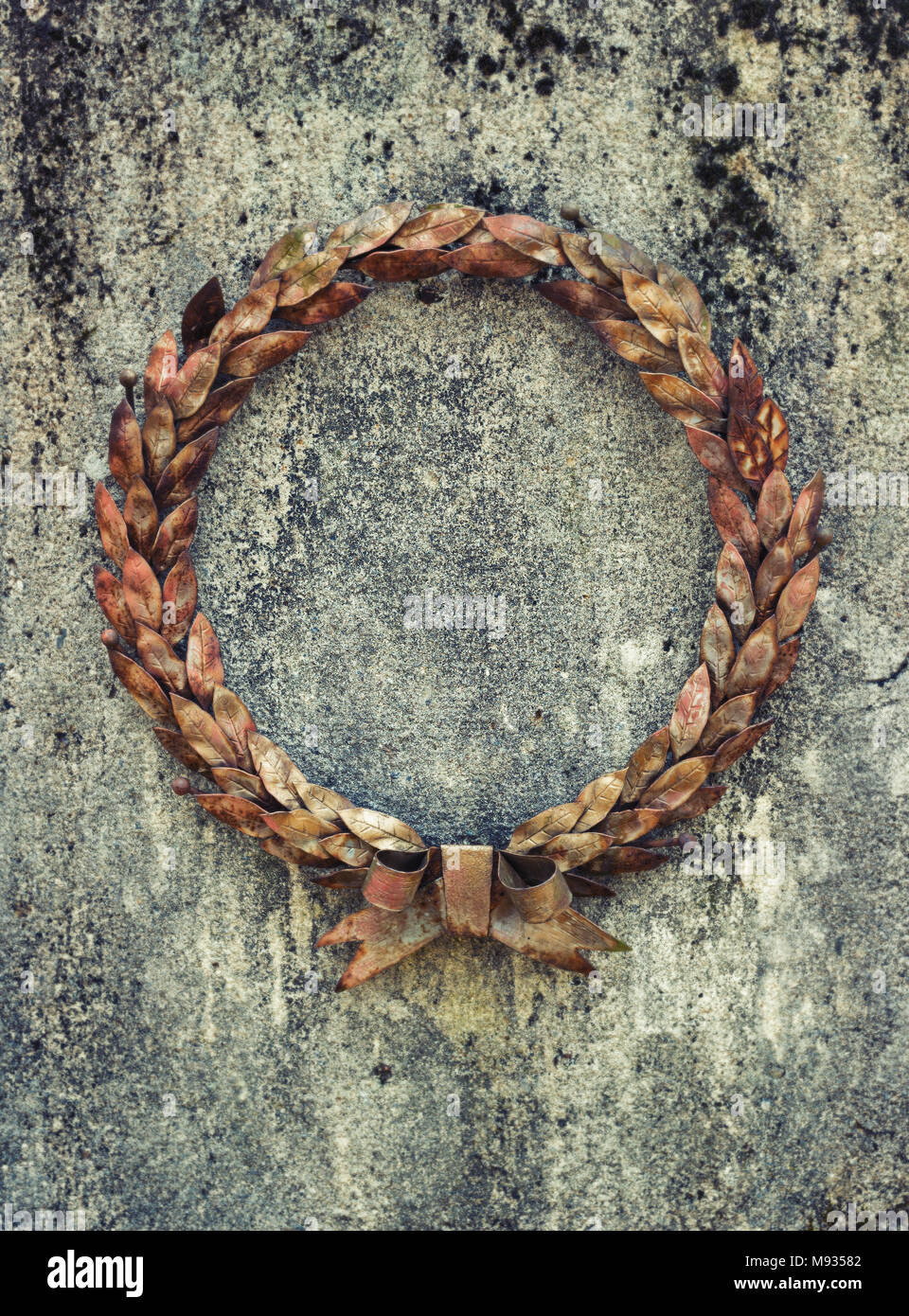 Old and weathered iron wreath on a stone tomb stone Stock Photo - Alamy