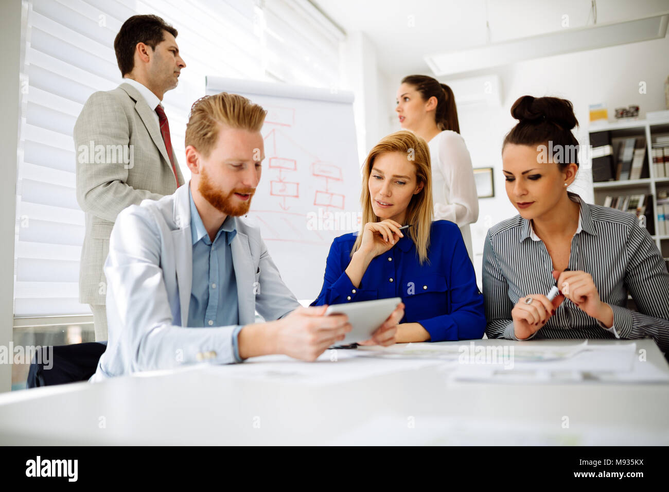 Collaborating business casual colleagues hi-res stock photography and ...