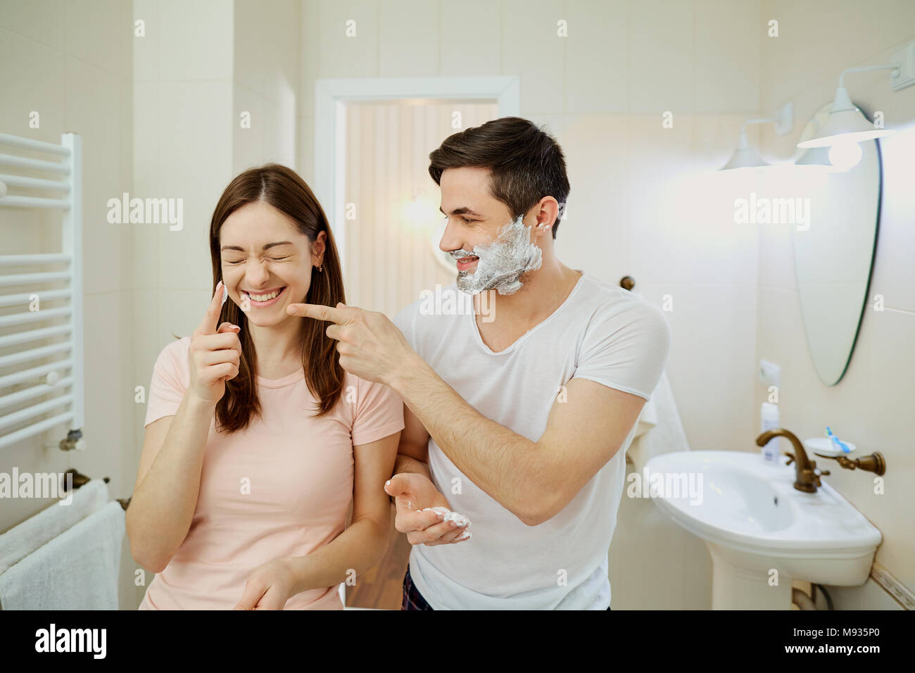 Couple in the morning personal hygiene in the bathroom Stock Photo - Alamy