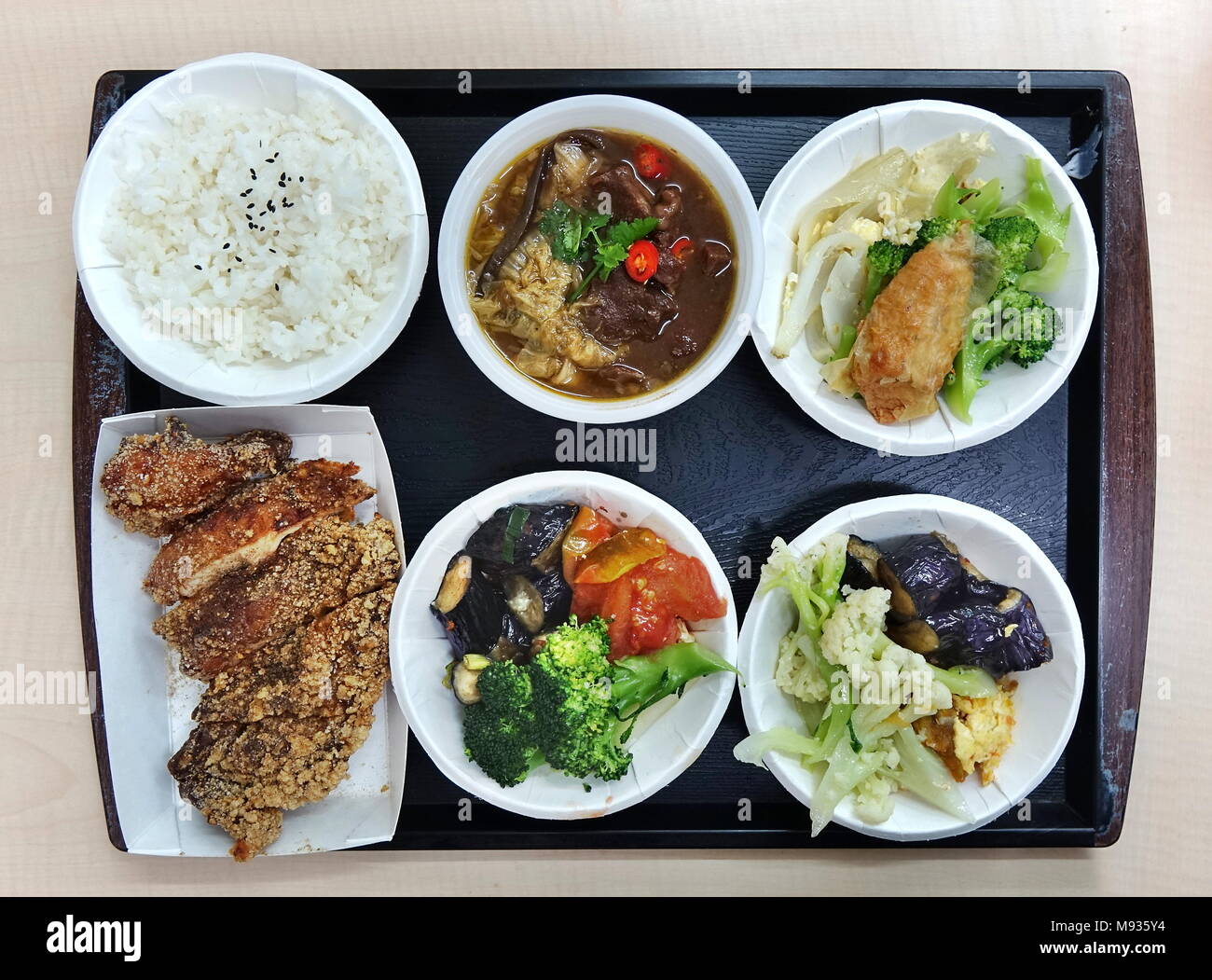A Chinese lunch set with fried chicken, beef stew and assorted ...