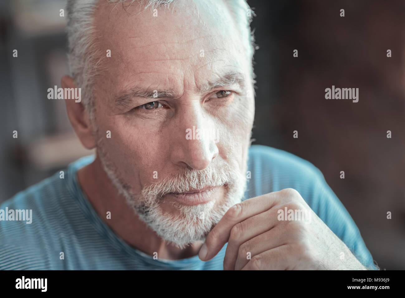Concentrated serious man looking aside and thinking Stock Photo - Alamy