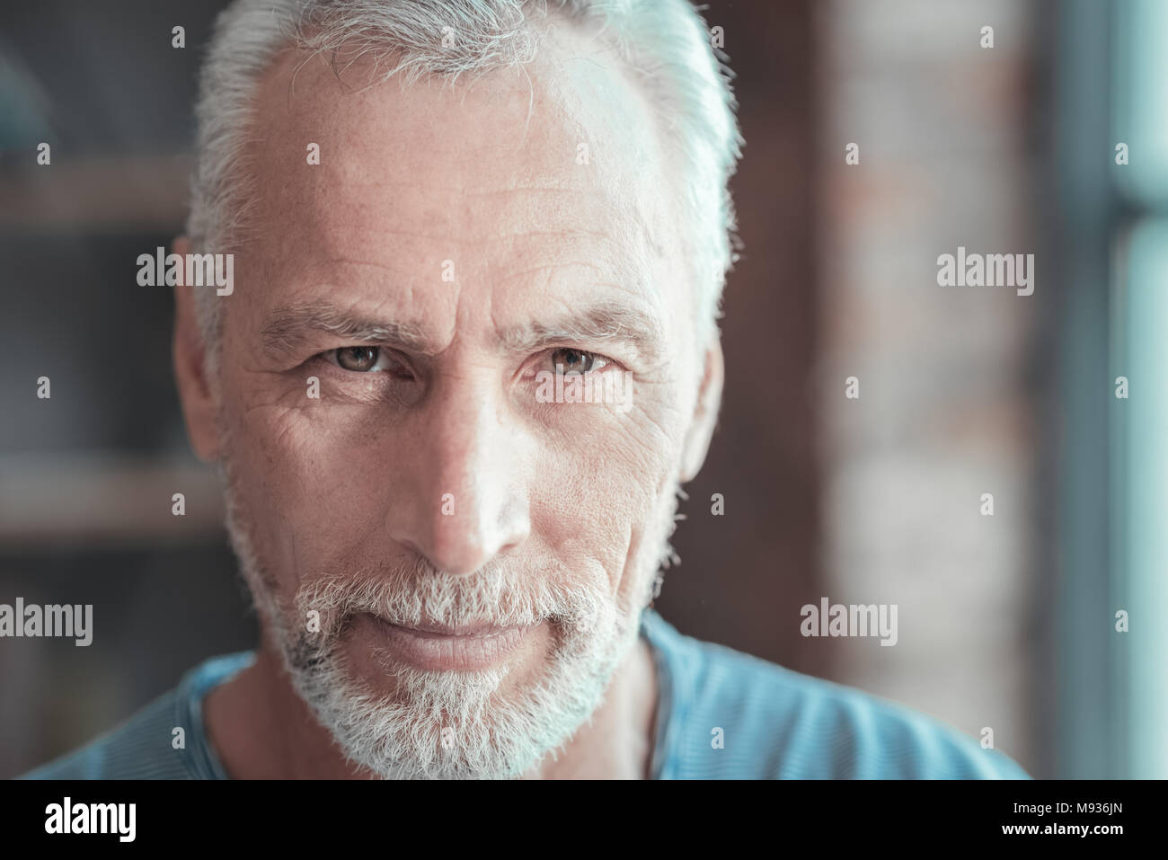Self-confident concentrated man keeping calm and looking straight Stock ...
