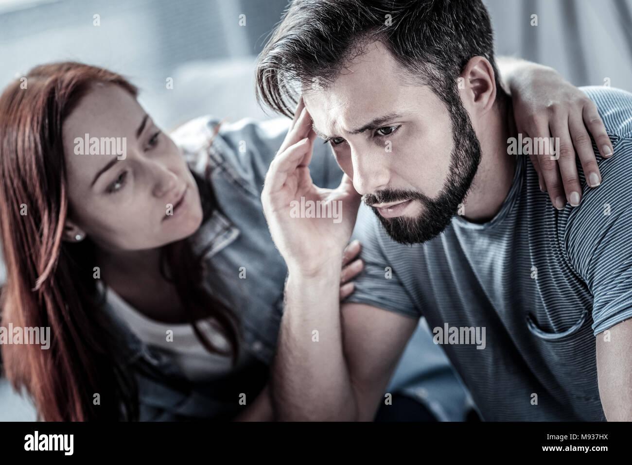 Deep upset man touching head and looking down Stock Photo - Alamy