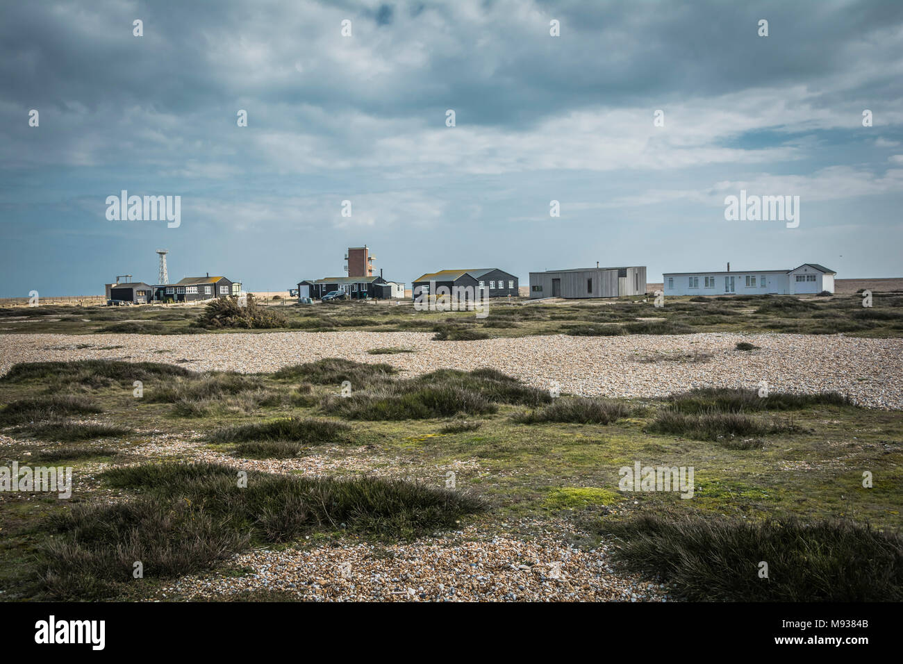 Buildings on a windswept Dungeness beach, Kent, England, UK Stock Photo ...
