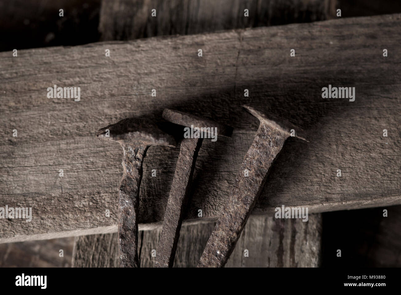 closeup of three rusty nails on a wooden cross, depicting the holy ...