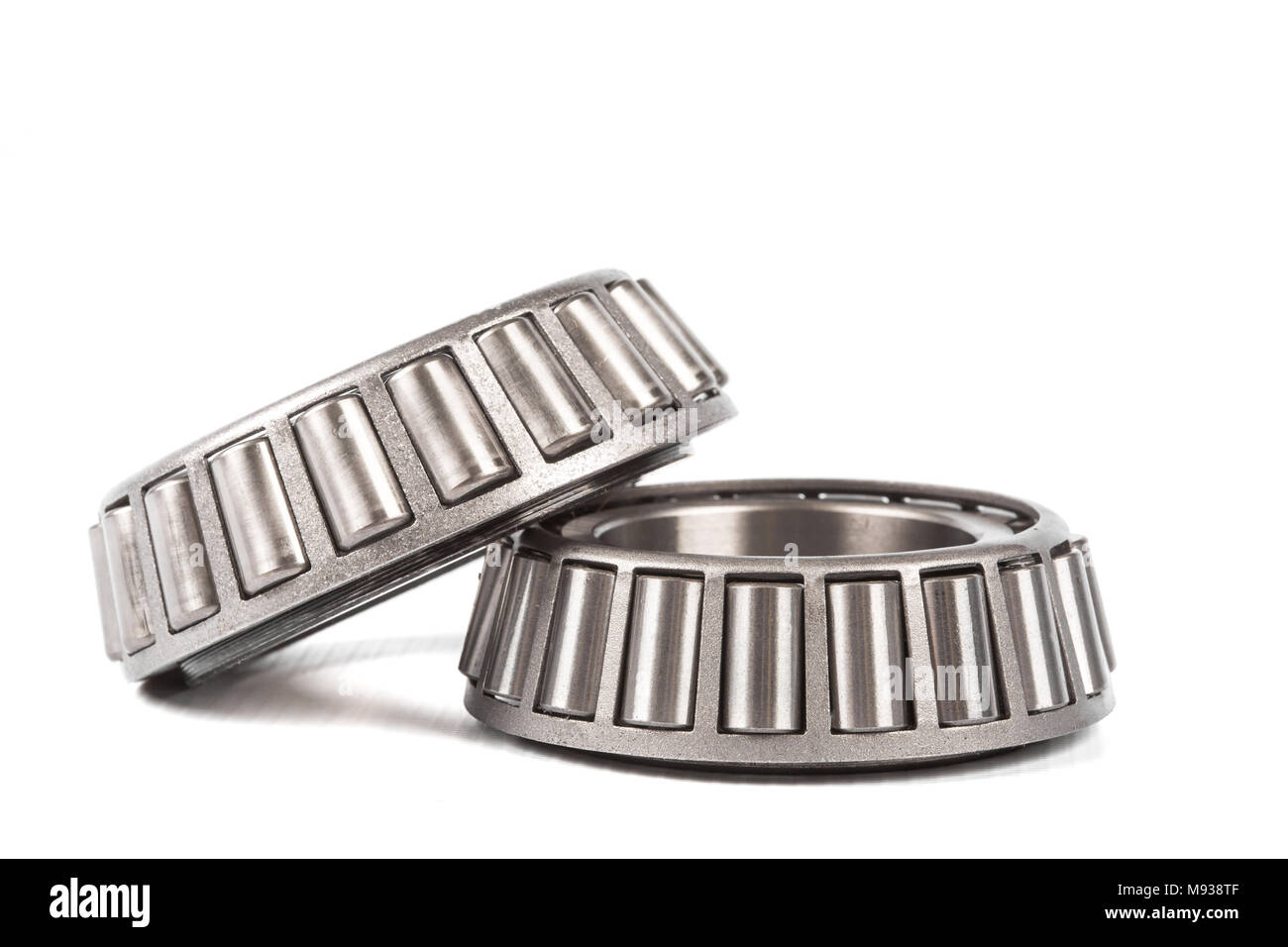Two precision metal bearings on a white background Stock Photo - Alamy