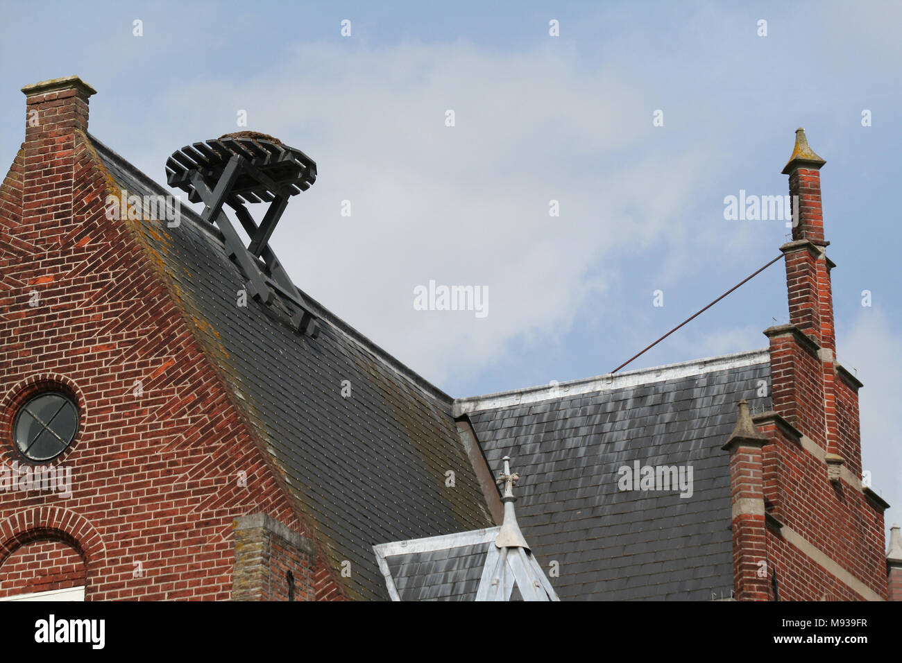 Netherlands,Gelderland,Culemborg, june 2016: empty stork nest on a roof ...