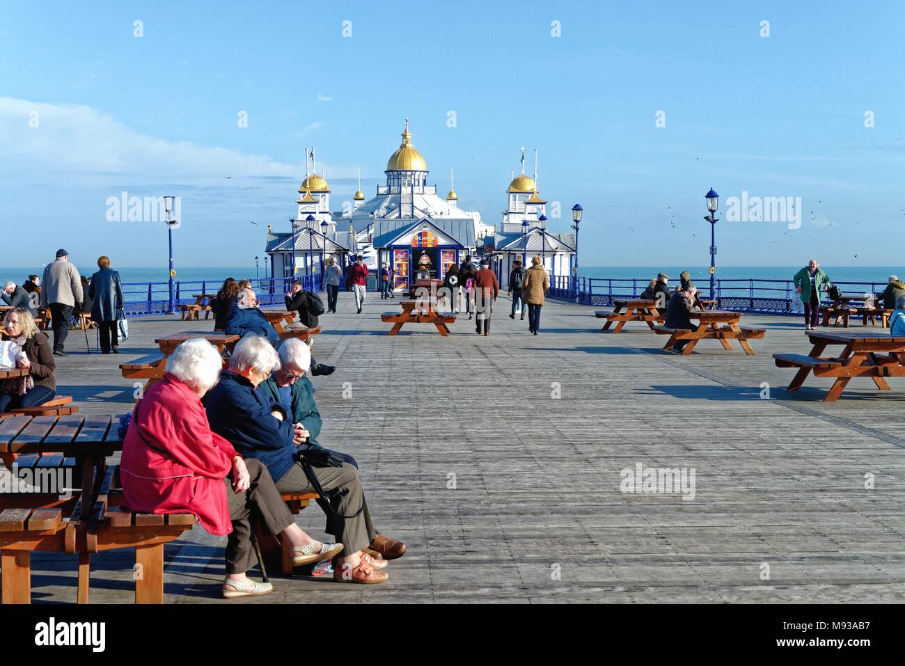 Elderly people enjoying the spring sunshine on Eastbourne pier, East ...