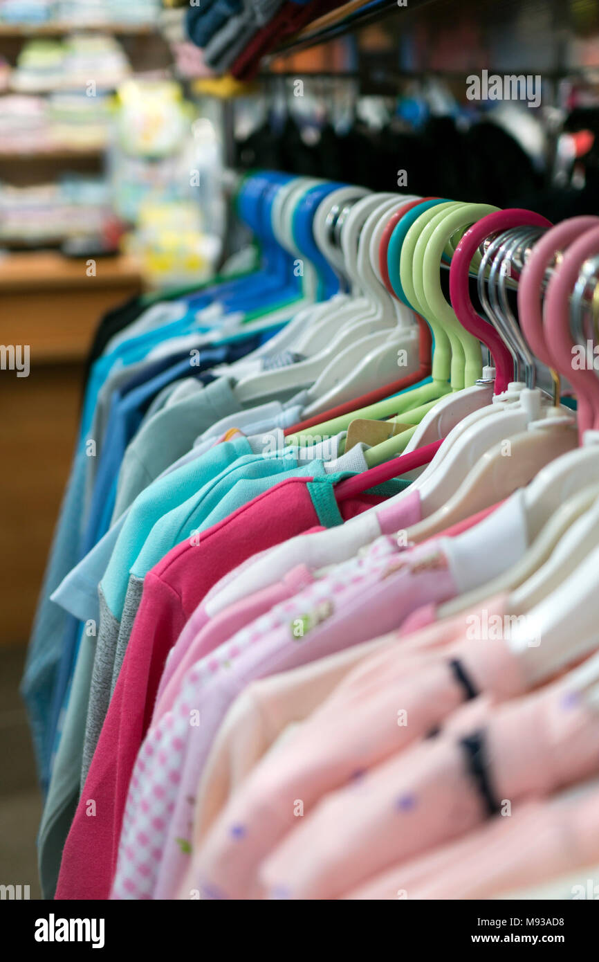clothes hanging on a hanger in a store Stock Photo - Alamy