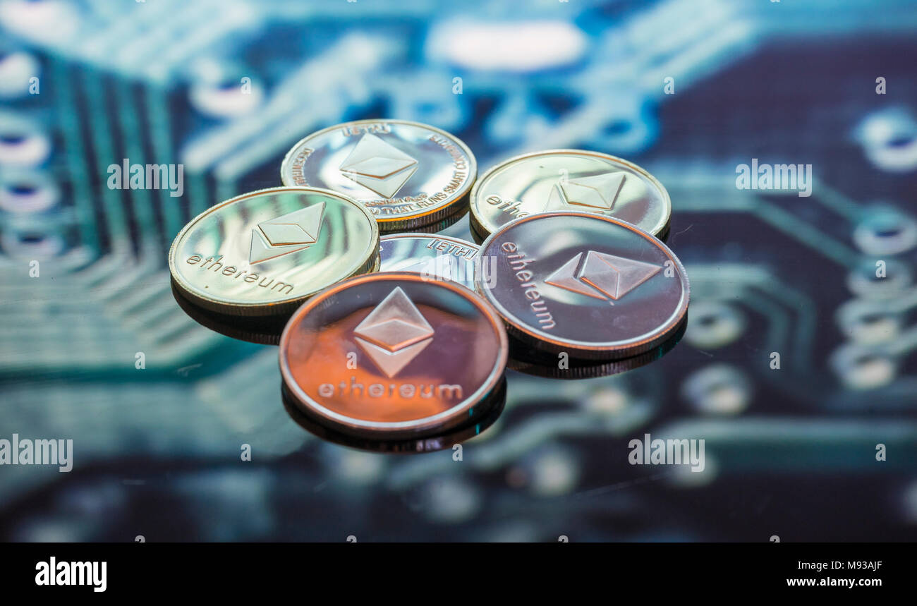 Economy, Ethereum gold, silver and copper coins and defocused printed ...