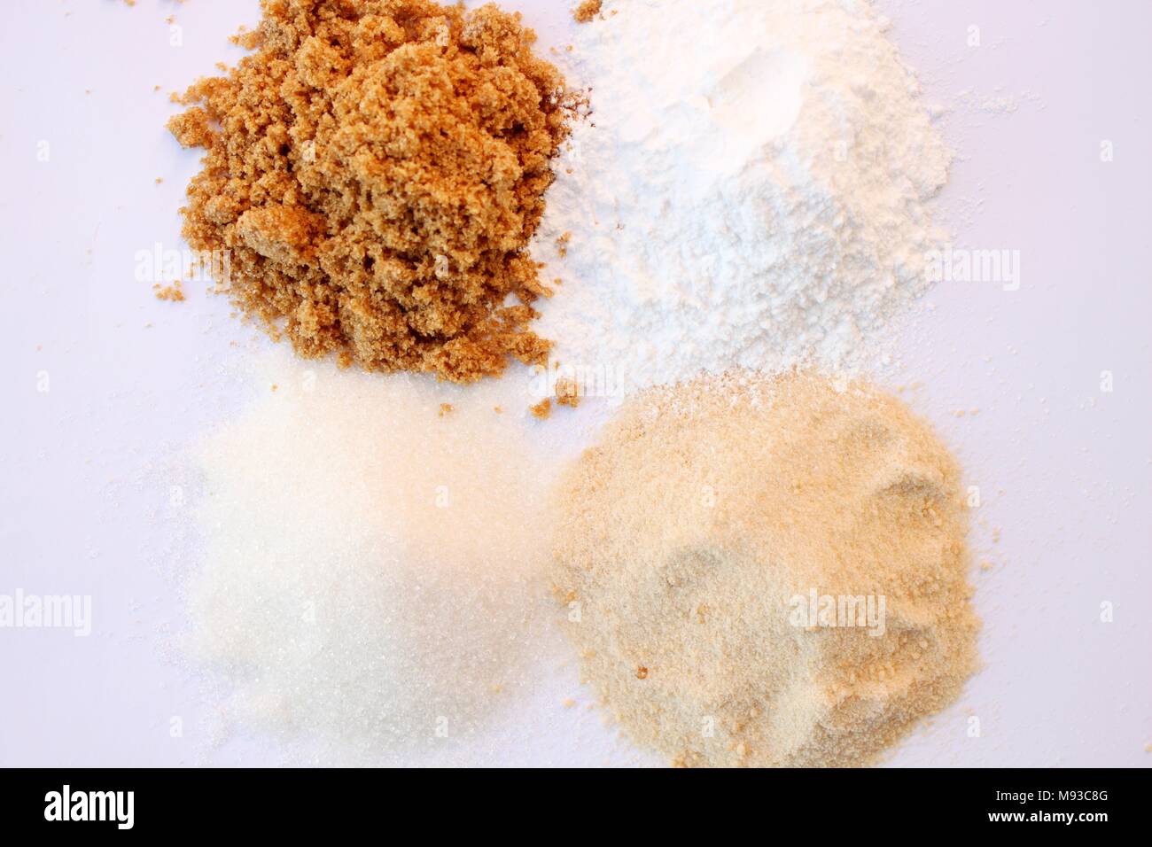 Four types of sugar on white background Stock Photo - Alamy
