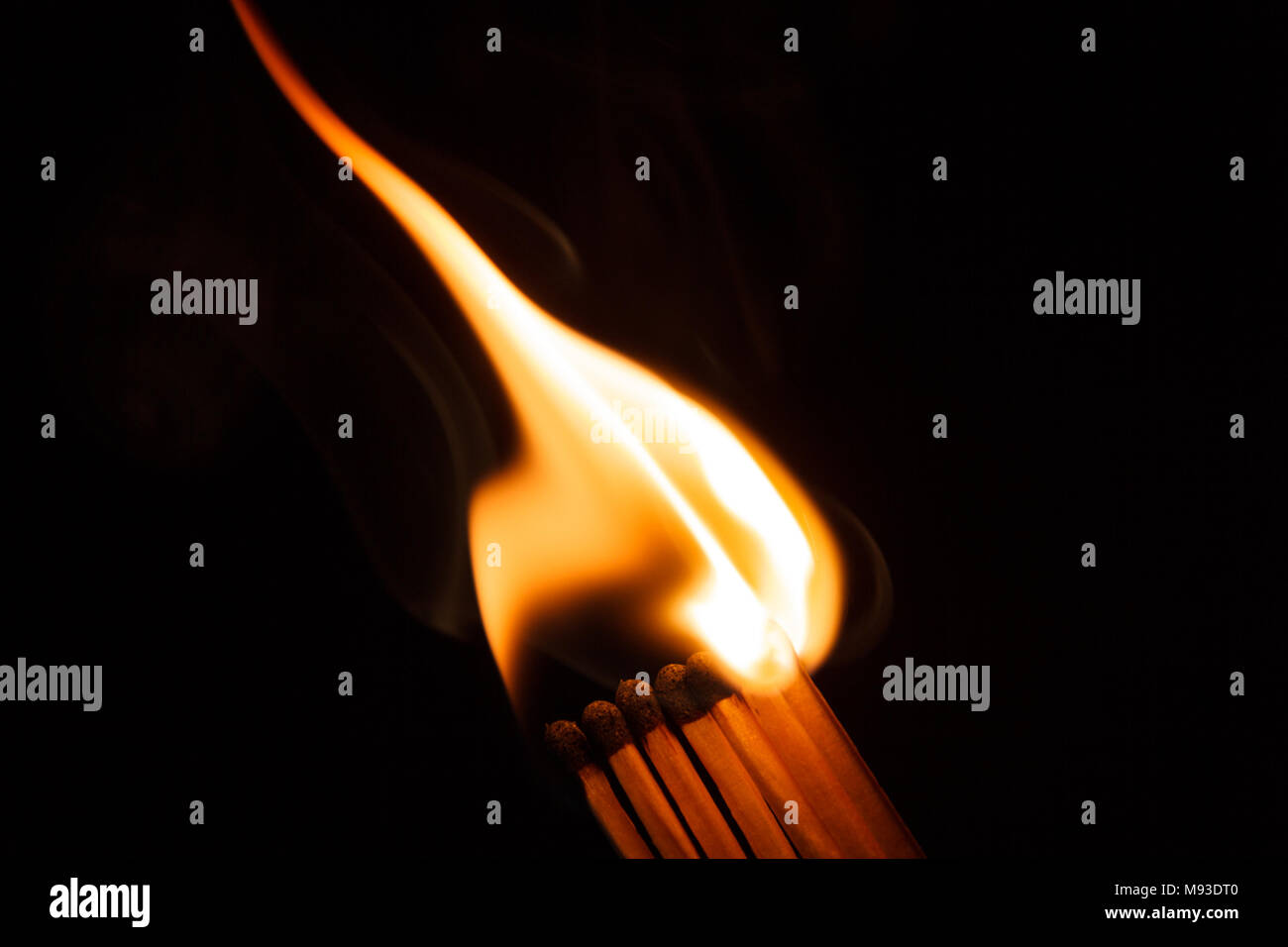 A row of matches is being ignited, spreading the fire Stock Photo - Alamy