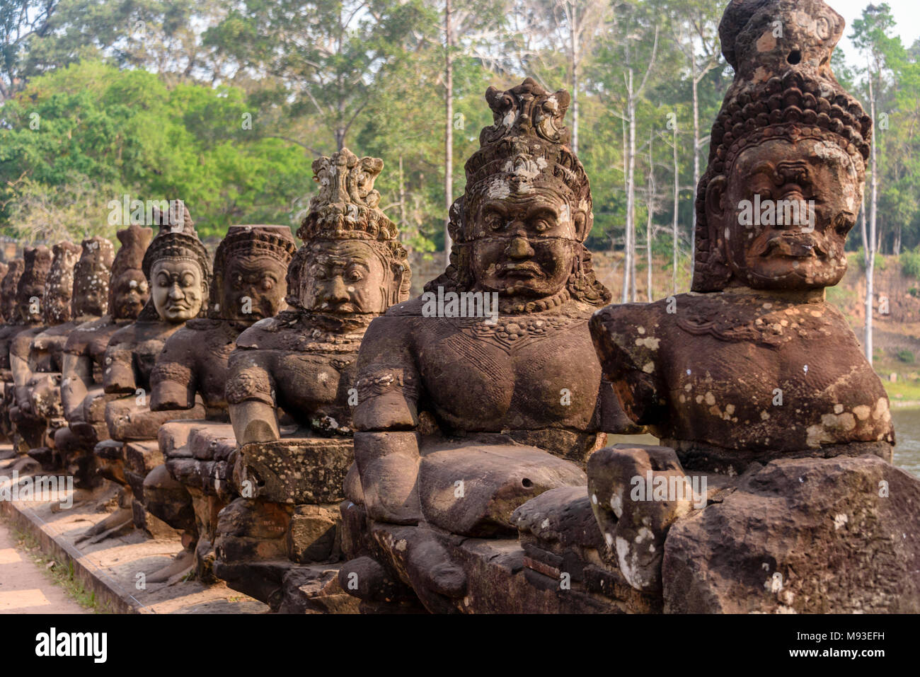 Statues line the entrance to the Unesco World Heritage site of Ankor ...