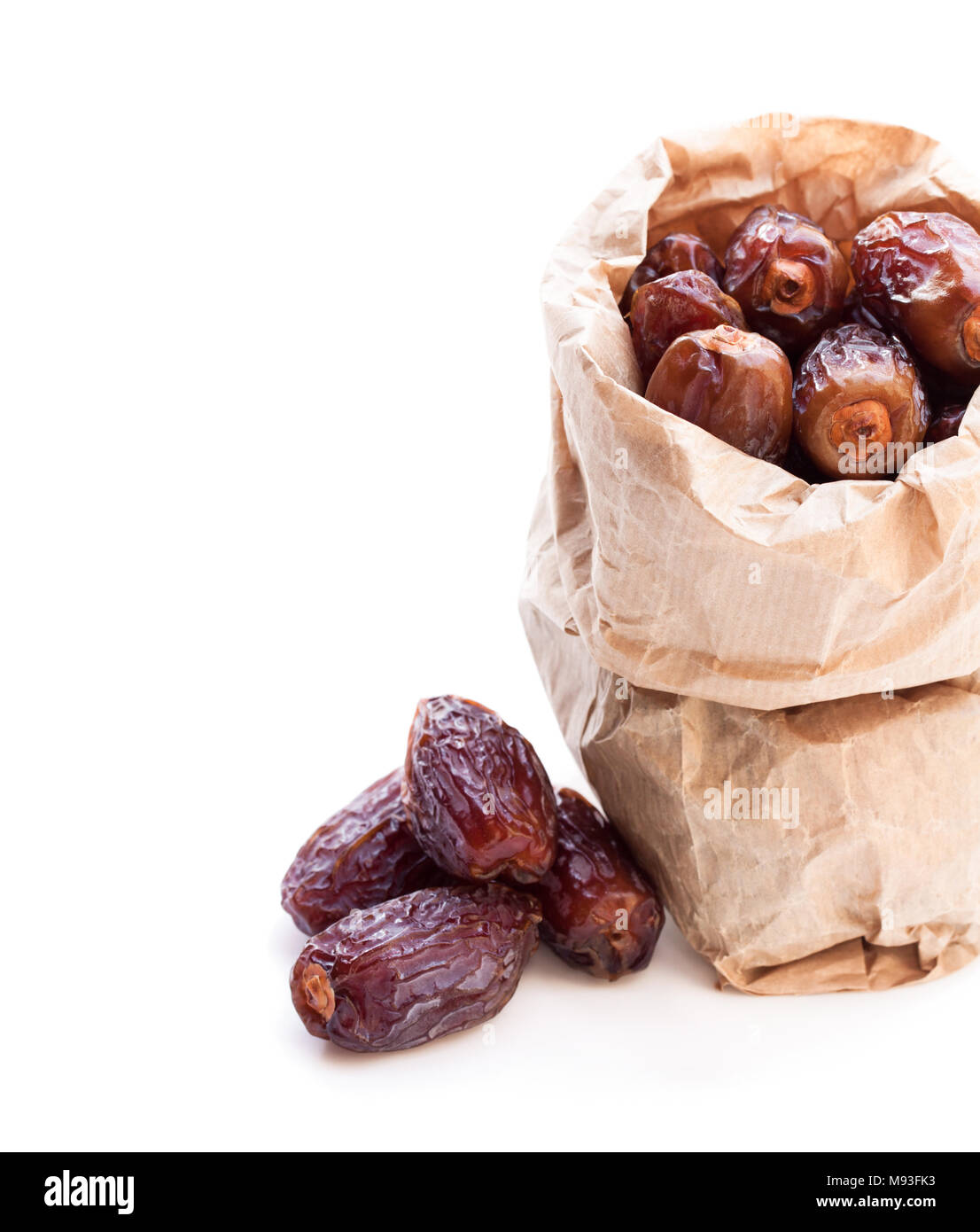 Dried dates in paper bag isolated on white Stock Photo - Alamy