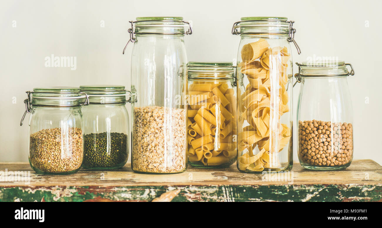 Uncooked cereals, grains, beans and pasta on table, wide composition ...