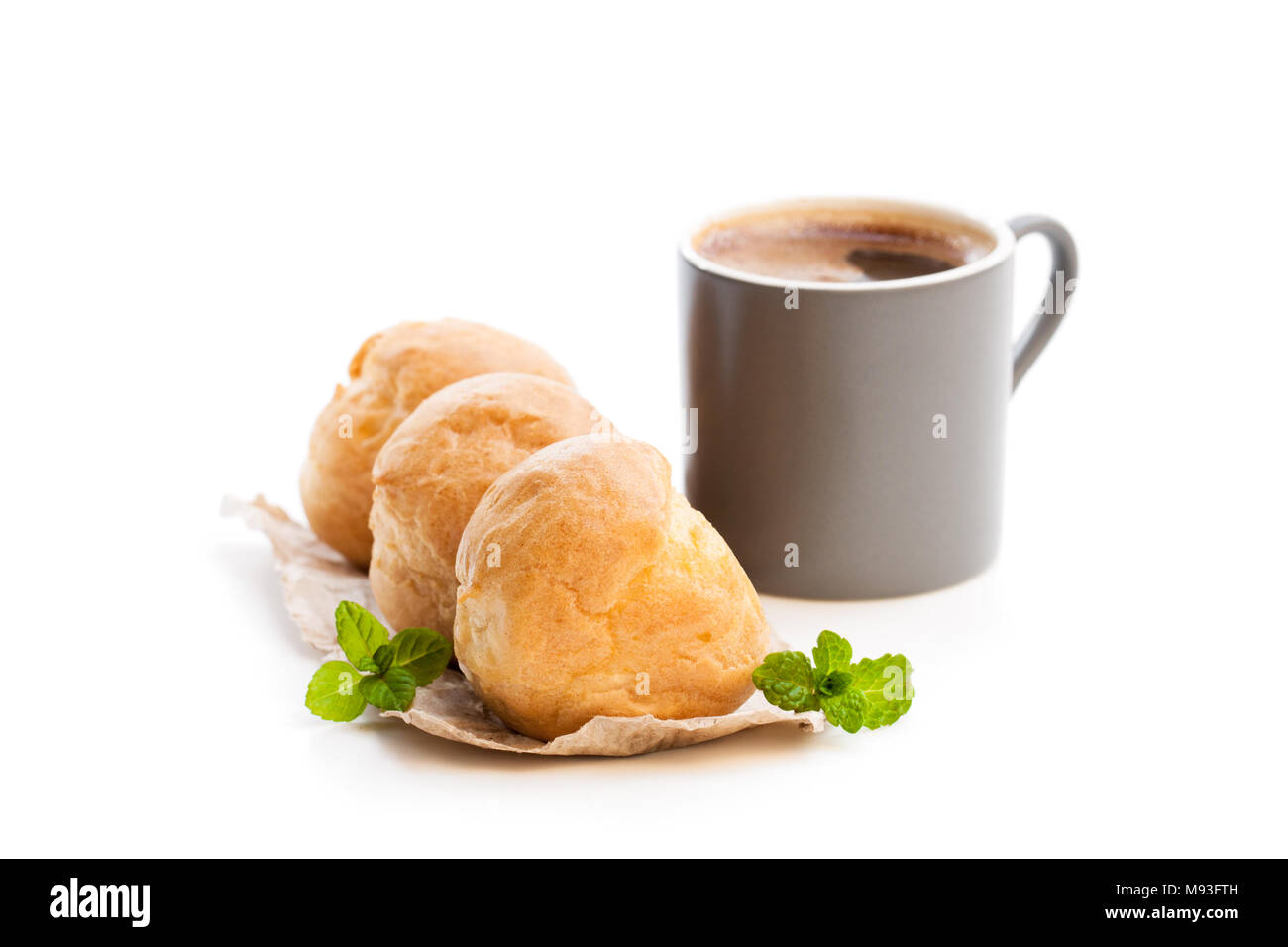 Homemade profiteroles with cup of coffee isolated on white Stock Photo ...