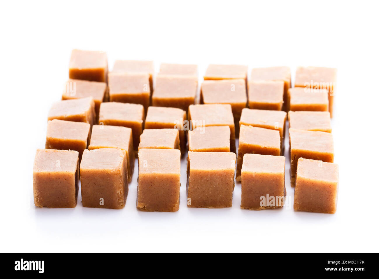 Toffee cubes isolated on white Stock Photo - Alamy