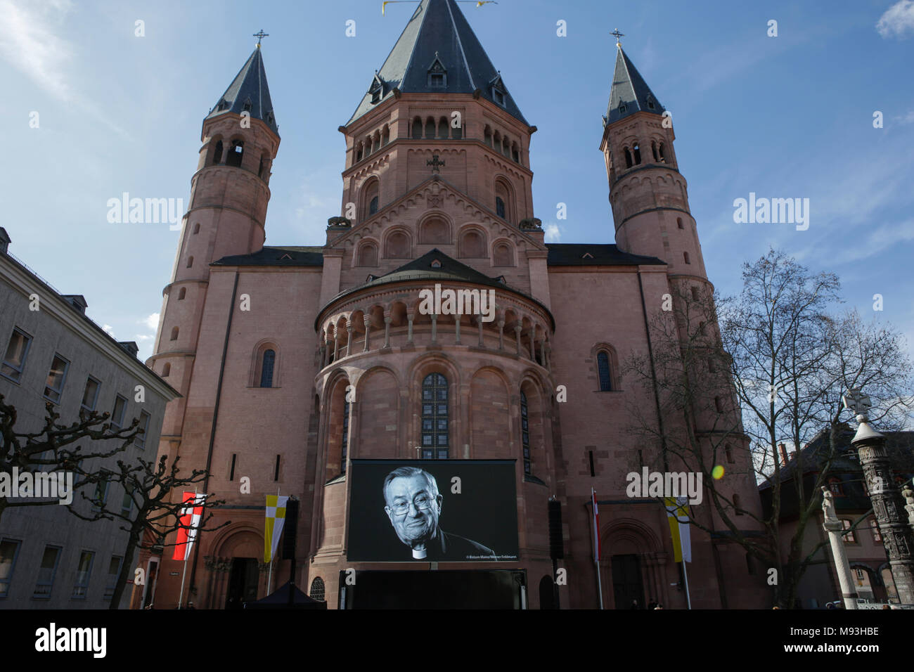 A large portrait of cardinal Lehman is shown on the screen outside ...