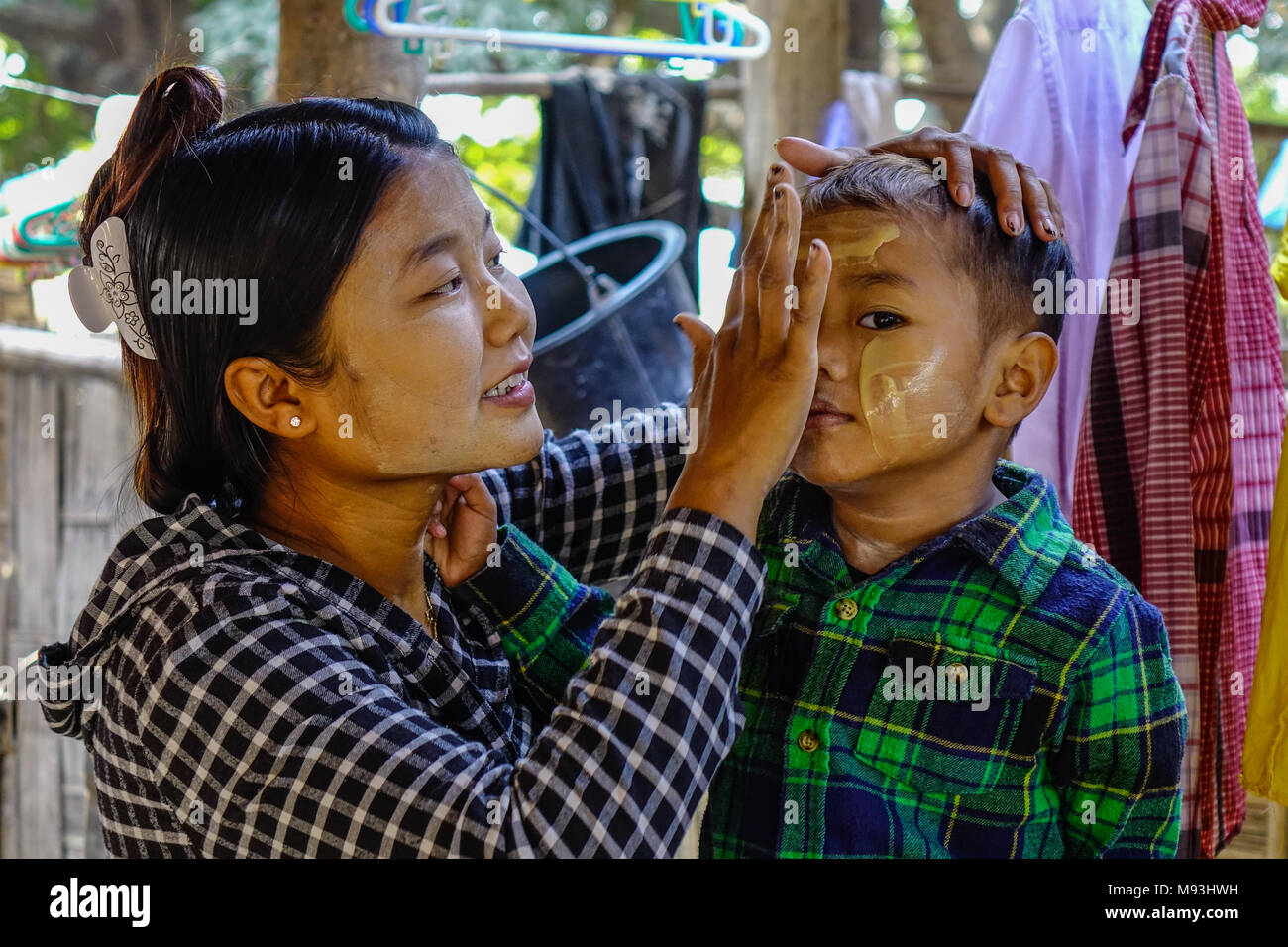 Mandalay, Myanmar - Feb 11, 2017. A Burmese woman putting Thanaka ...