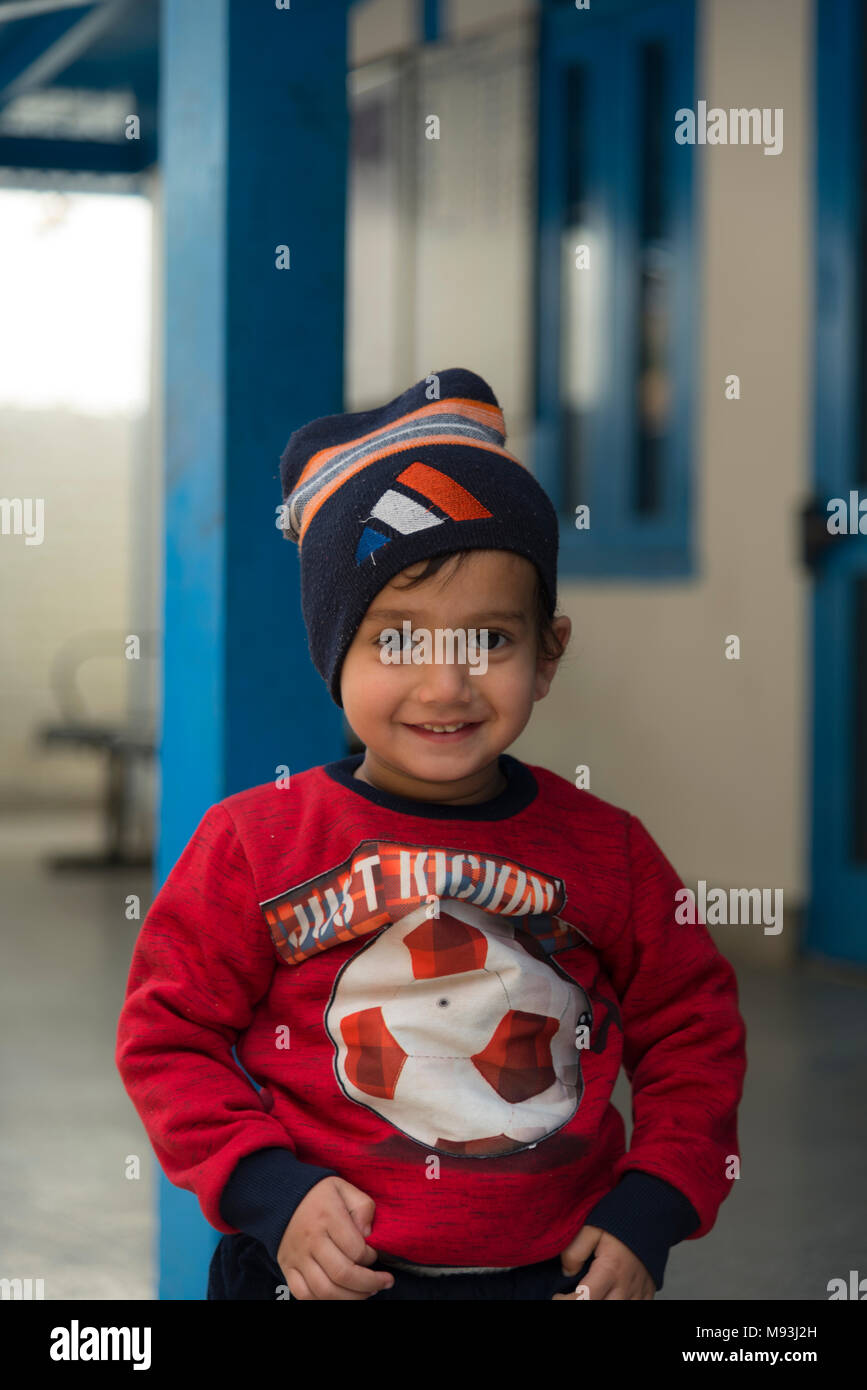 cute smiling kid face expression with fair complexion wearing red dress ...