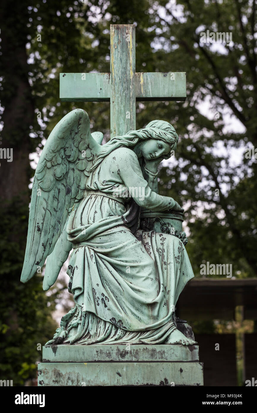 Angel in front of cross in mourning Stock Photo - Alamy