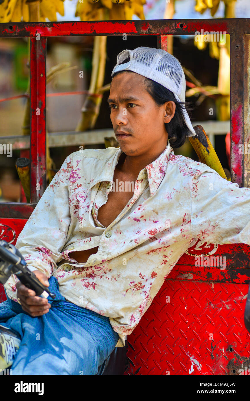 Mandalay, Myanmar - Feb 11, 2017. Portrait of Burmese man at the street ...
