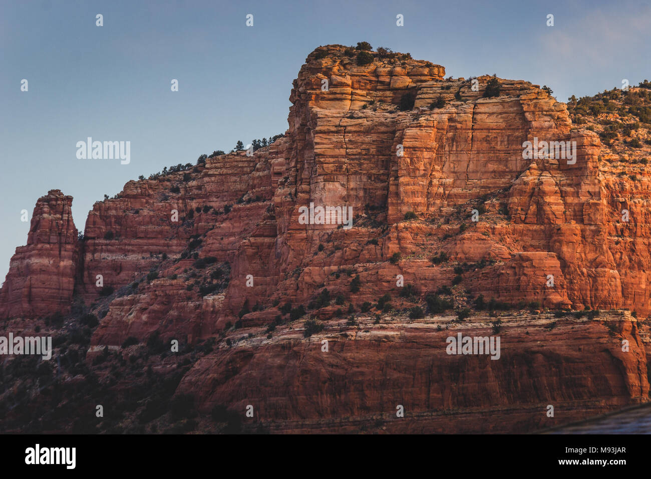 Majestic red rock formations with dramatic shadows at sunrise with ...