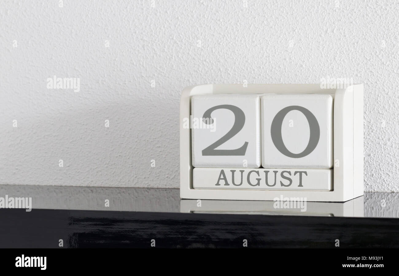 White block calendar present date 20 and month August on white wall ...