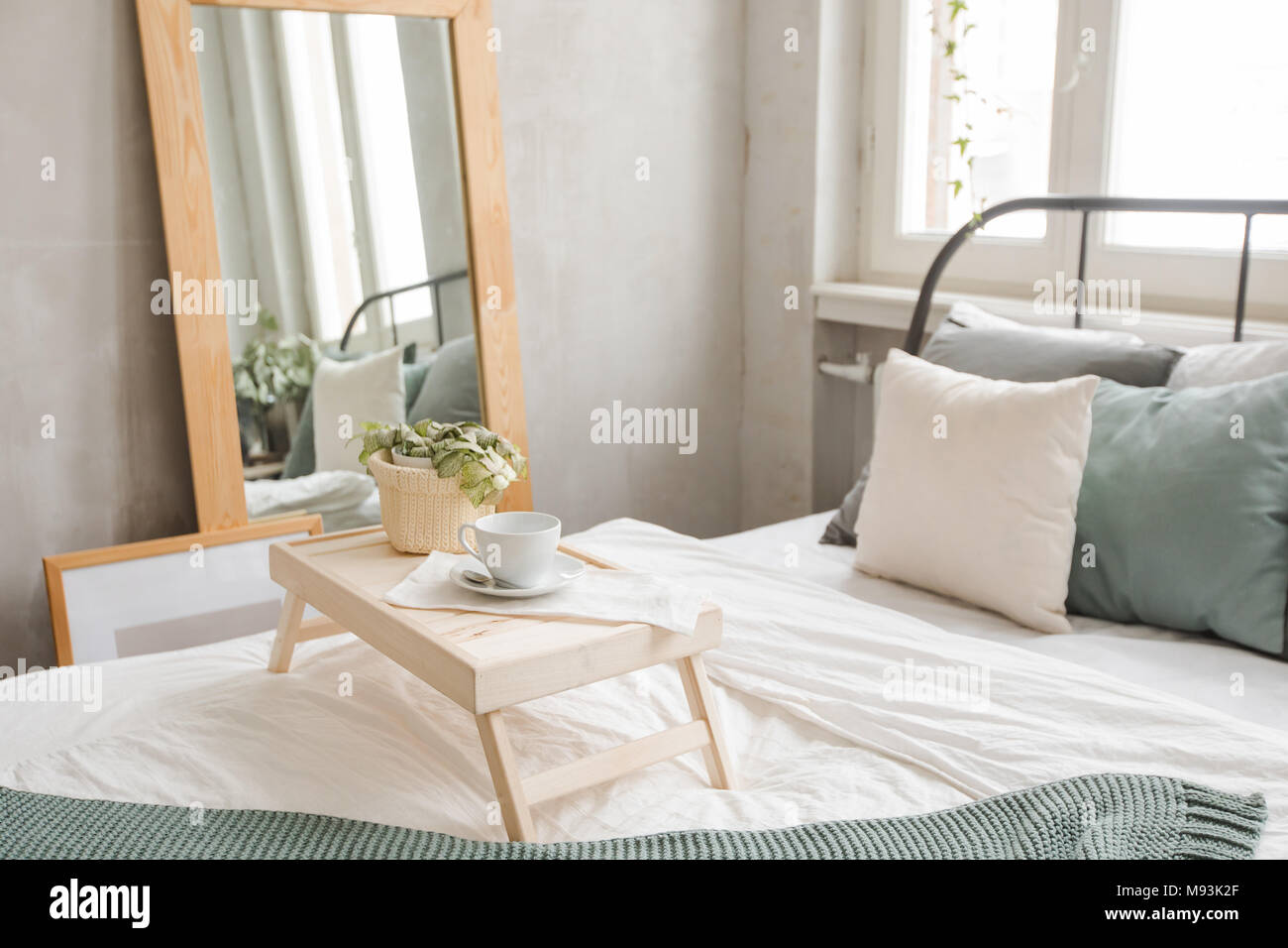 Cozy bed with small table for breakfast Stock Photo - Alamy