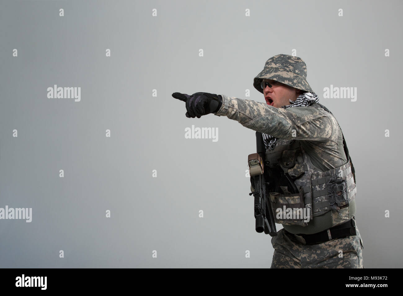 Picture of military man in helmet with hand pointing to side Stock ...