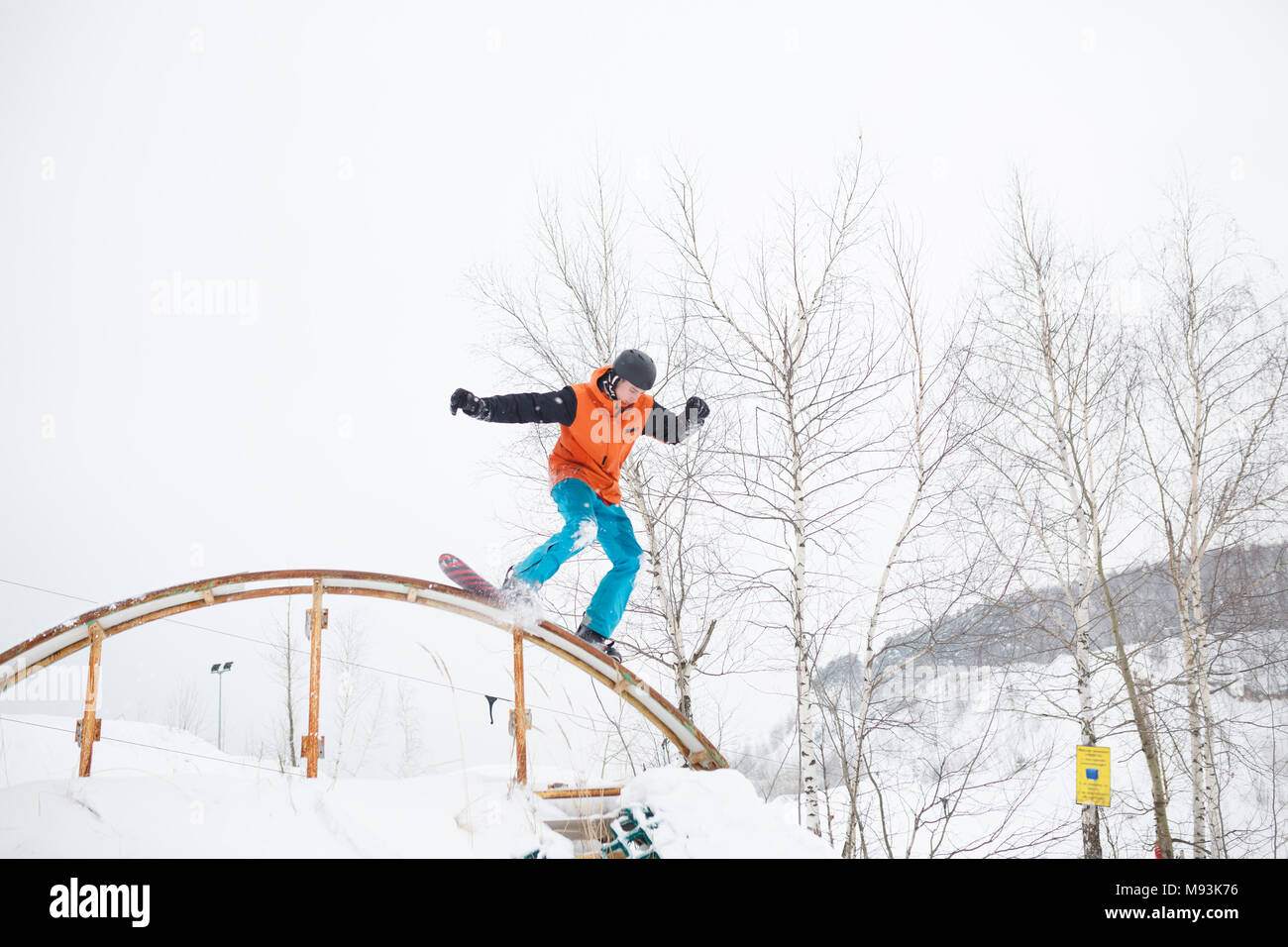Image of athlete skating on snowboard from springboard against ...