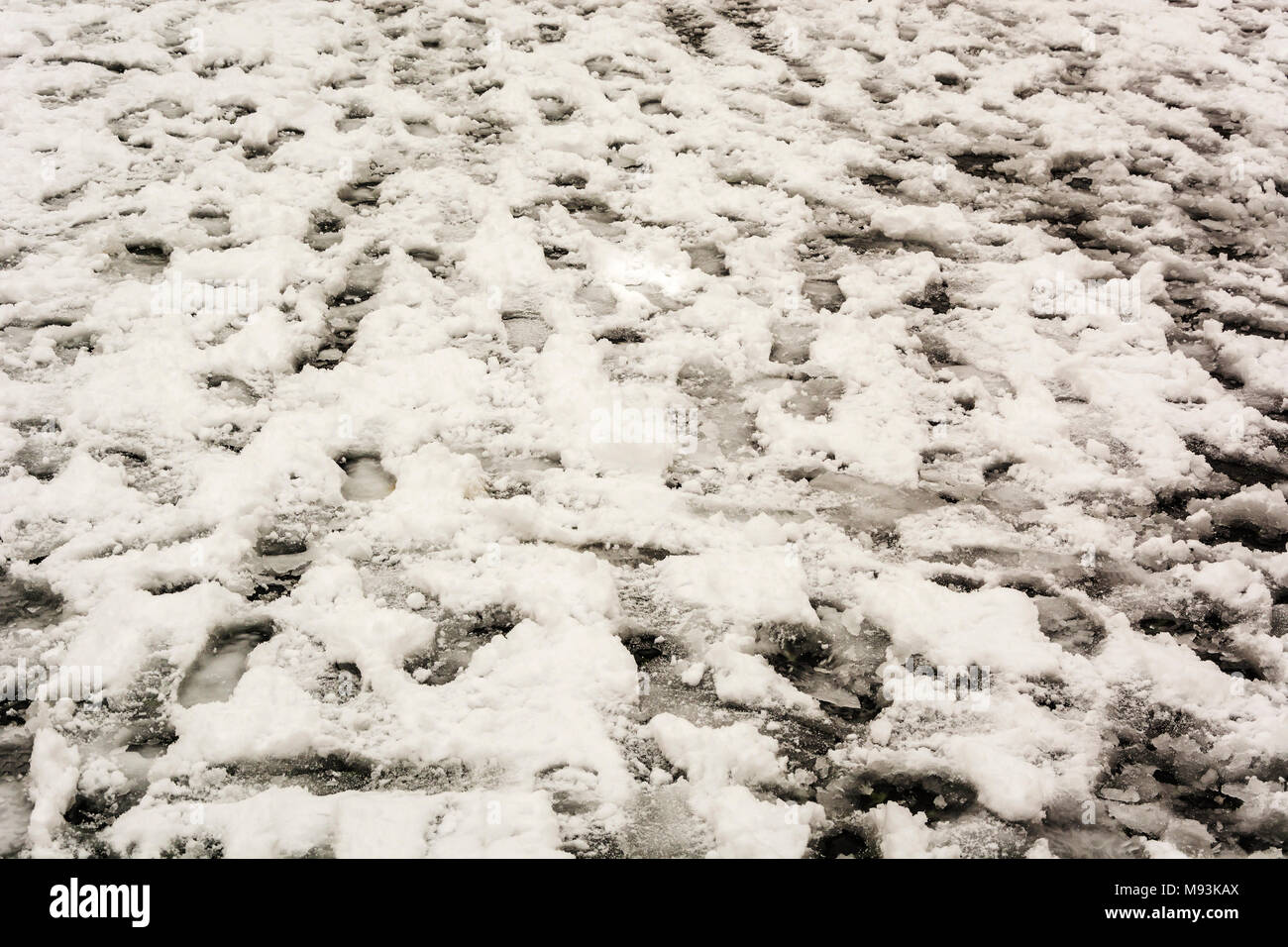 melted snow with footprints. Seasonal concept Stock Photo - Alamy