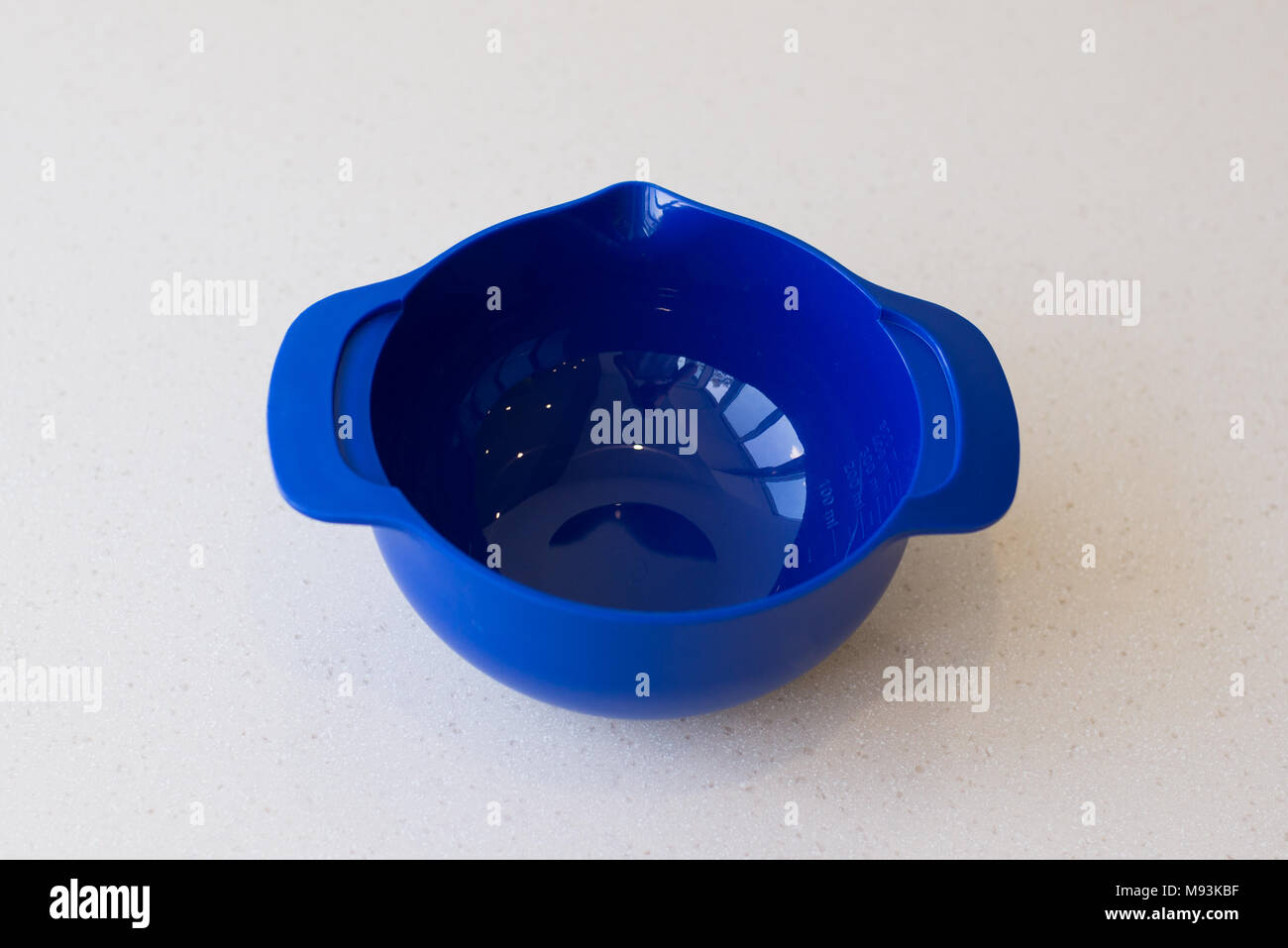 Plastic cups of a multi-colored dish in the kitchen Stock Photo - Alamy